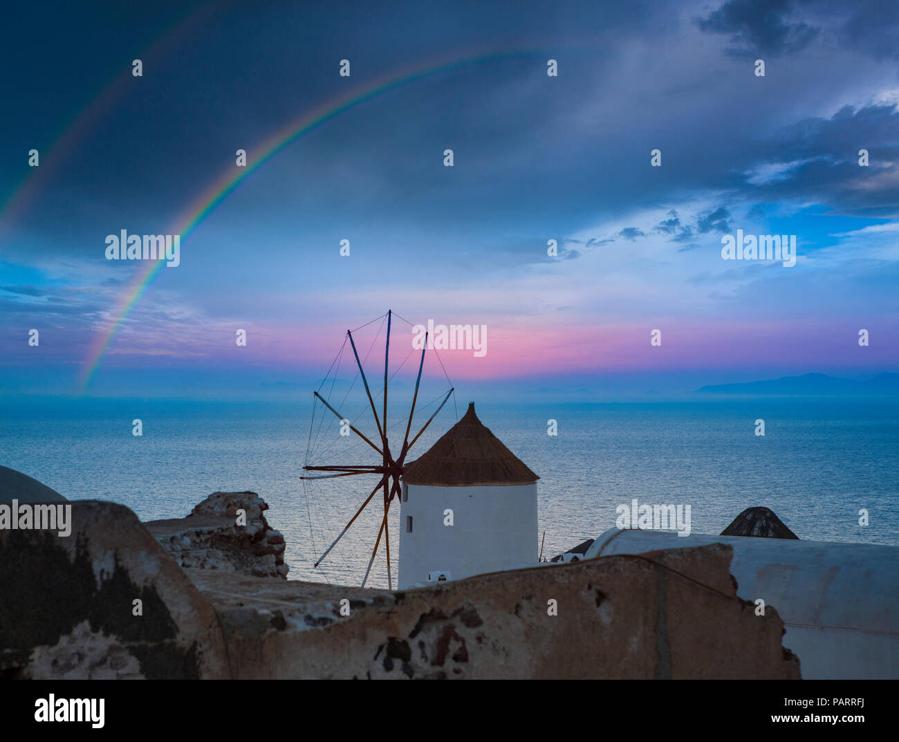 Rainbow drama before sunset. The shot is taken at Oia,Santorini at ...