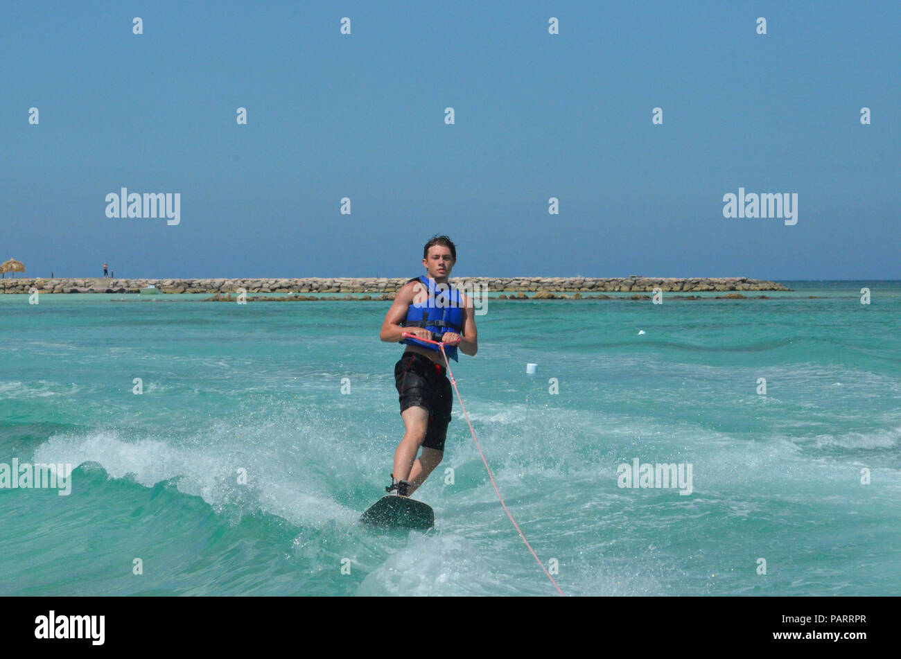 Guy wakeboarding and standing up in Aruba Stock Photo - Alamy