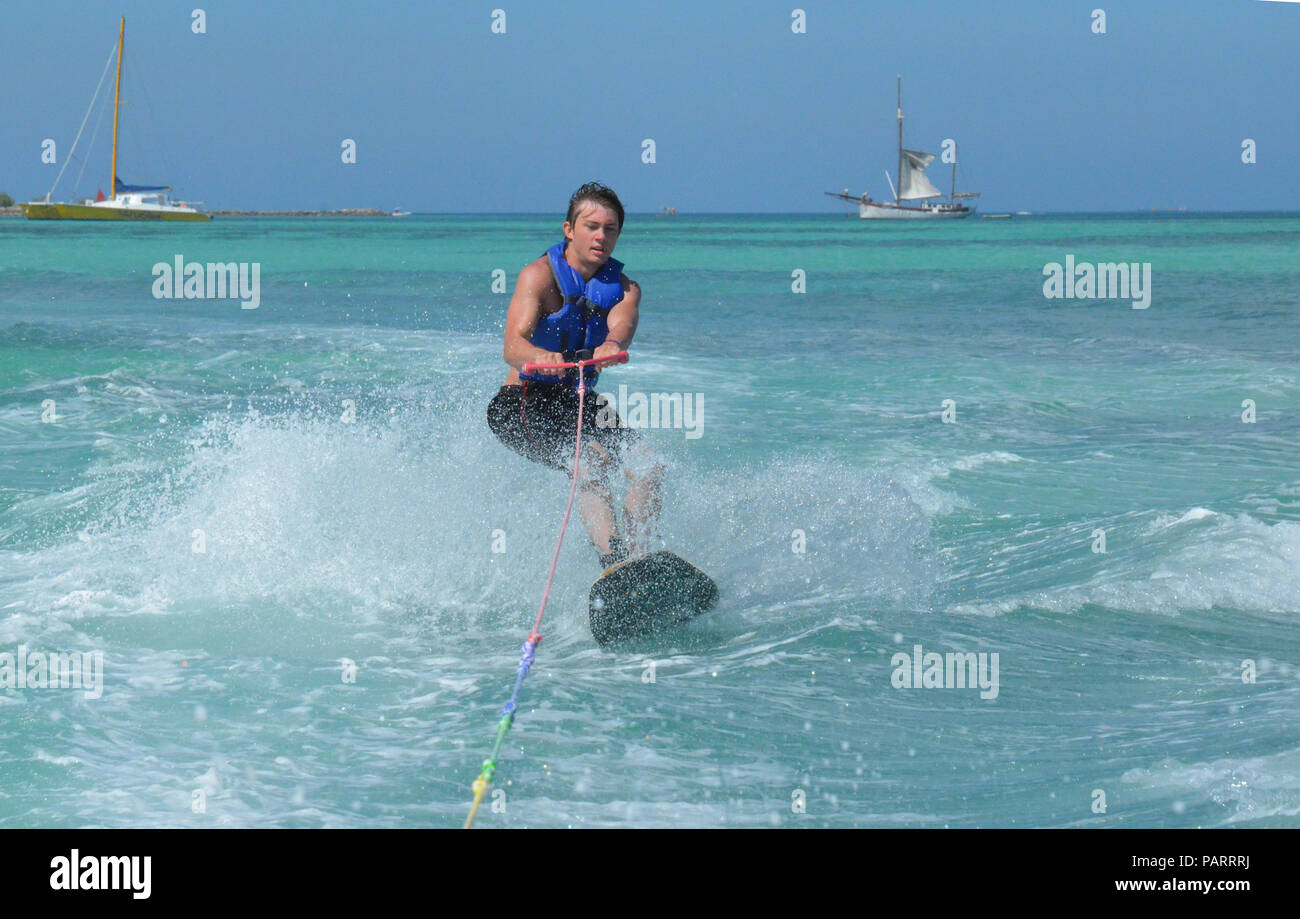 Young wakeboarder landing a big jump with a splash in Aruba Stock Photo ...