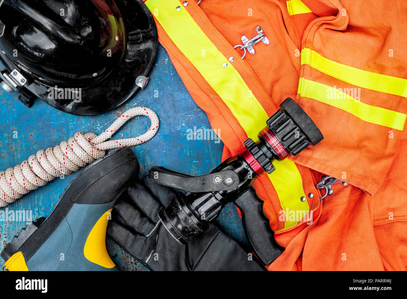 Outfit of Firefighter placed on old table background, Fire equipment ...