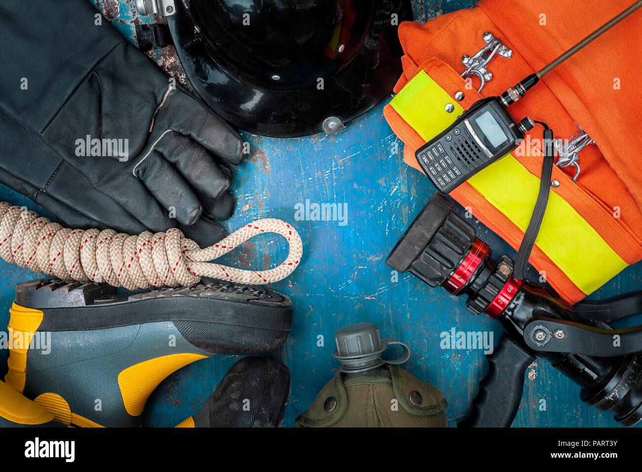 Outfit of Firefighter placed on old table background, Fire equipment ...