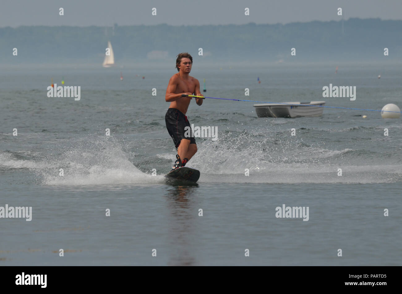 Young guy wakeboarding in Casco Bay Maine Stock Photo - Alamy