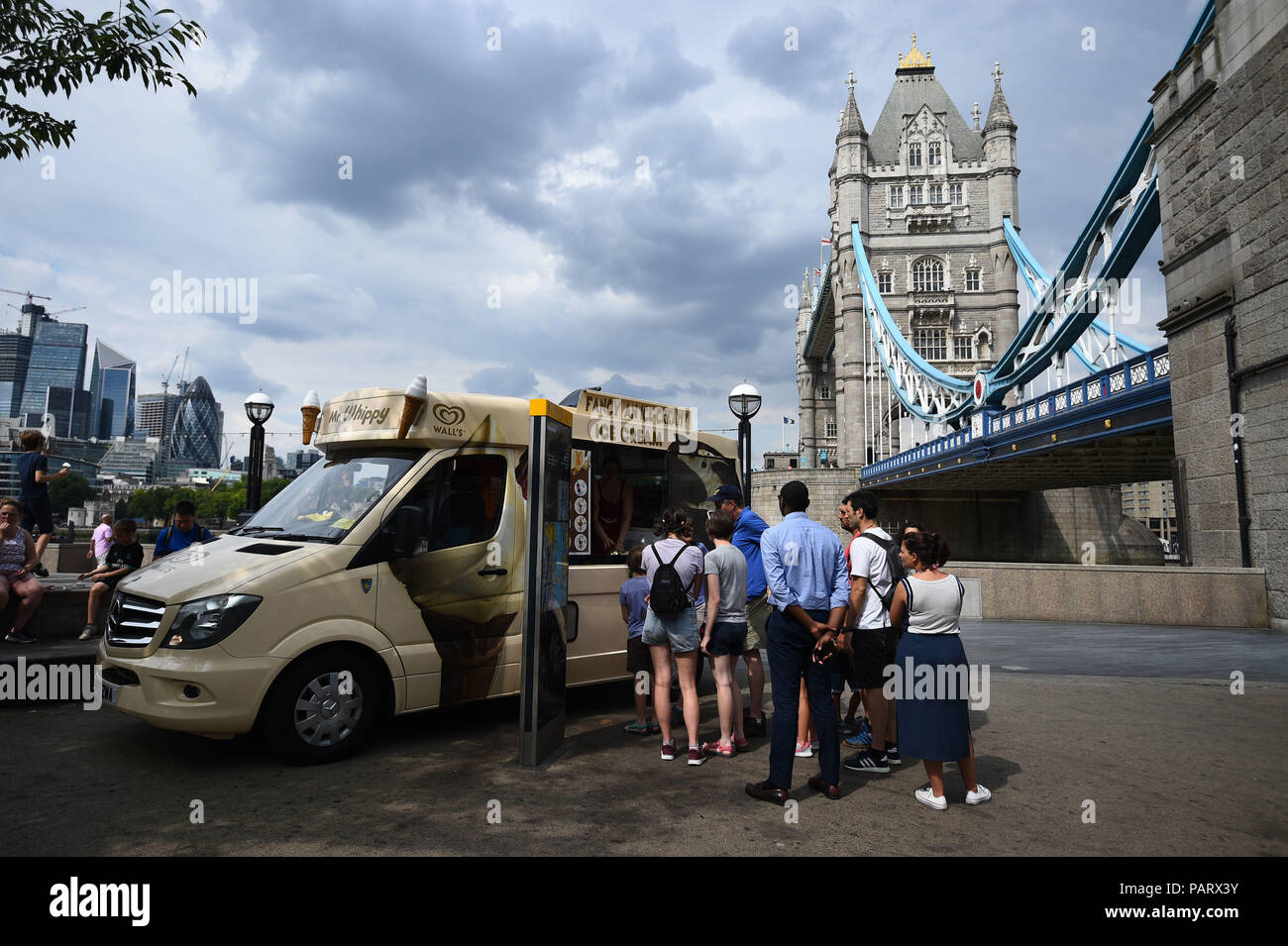 People queue for ice-cream at Tower Bridge in London, as the hot ...