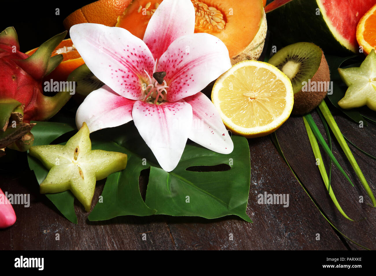 Tropical fruit. Assortment of tropical fruits with leaves of palm trees ...