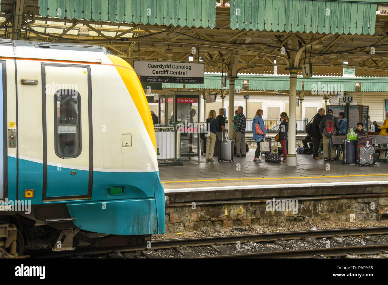 Passengers on platform at Cardiff Central Station with the front of a ...
