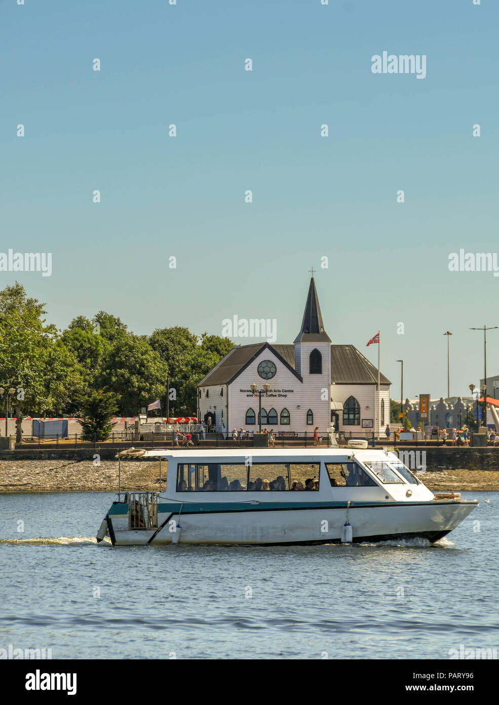 Small water taxi taking passengers across Cardiff Bay passing the ...