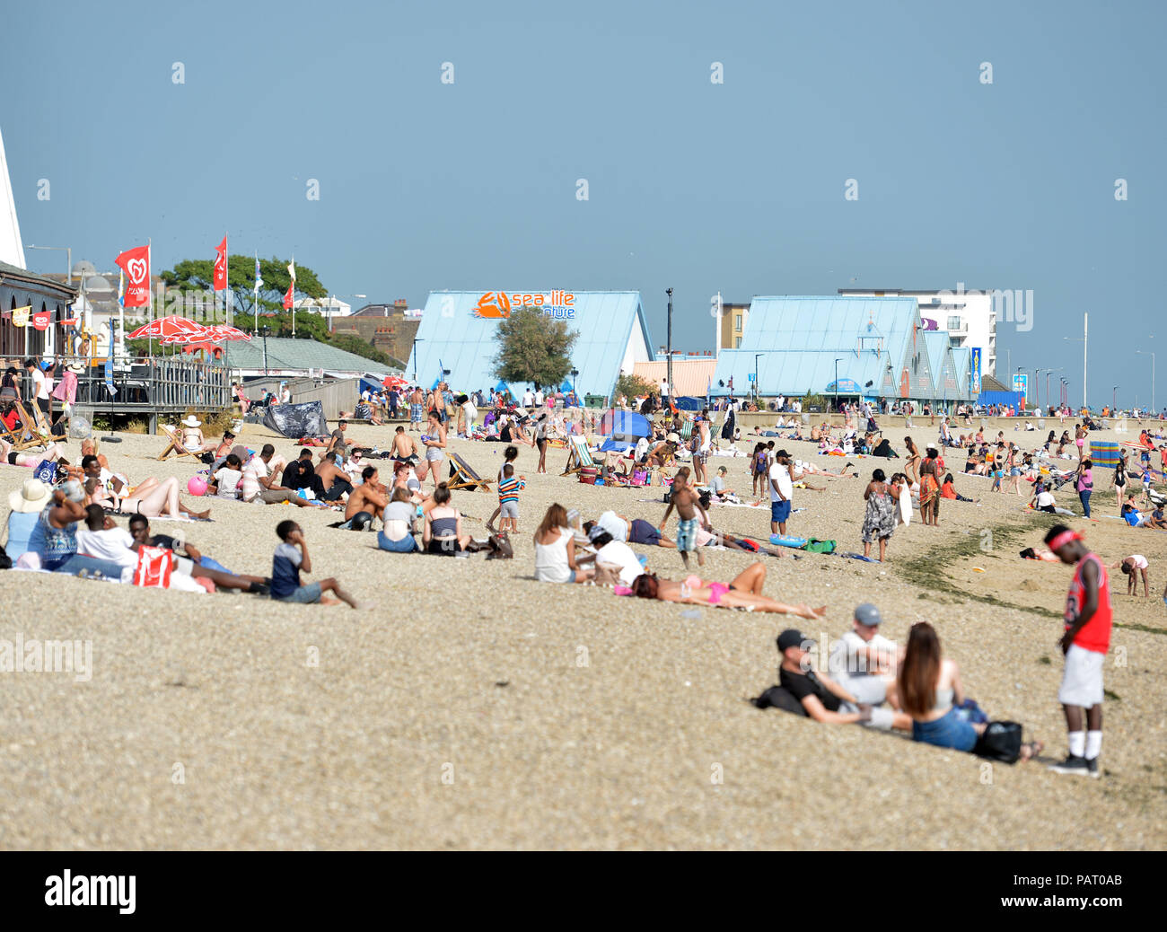 People enjoy the late afternoon sun on the beach in Southend, Essex, as ...