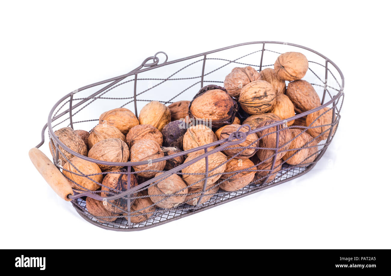 group of seasonal autumn nuts in a metal basket isolated on white ...
