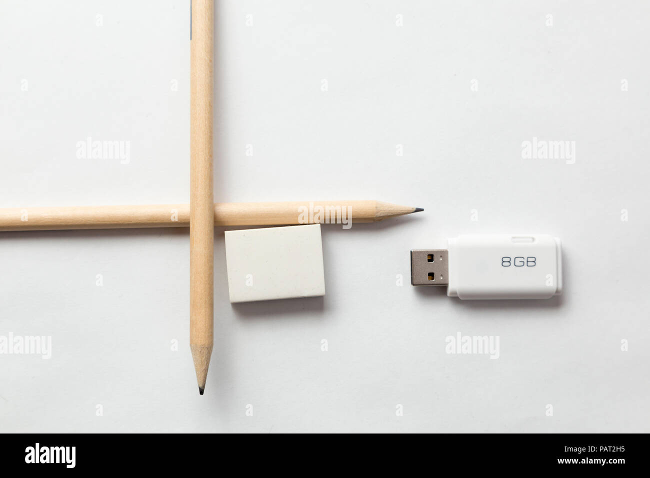 two pencils, a flash drive and an eraser on a white background Stock ...