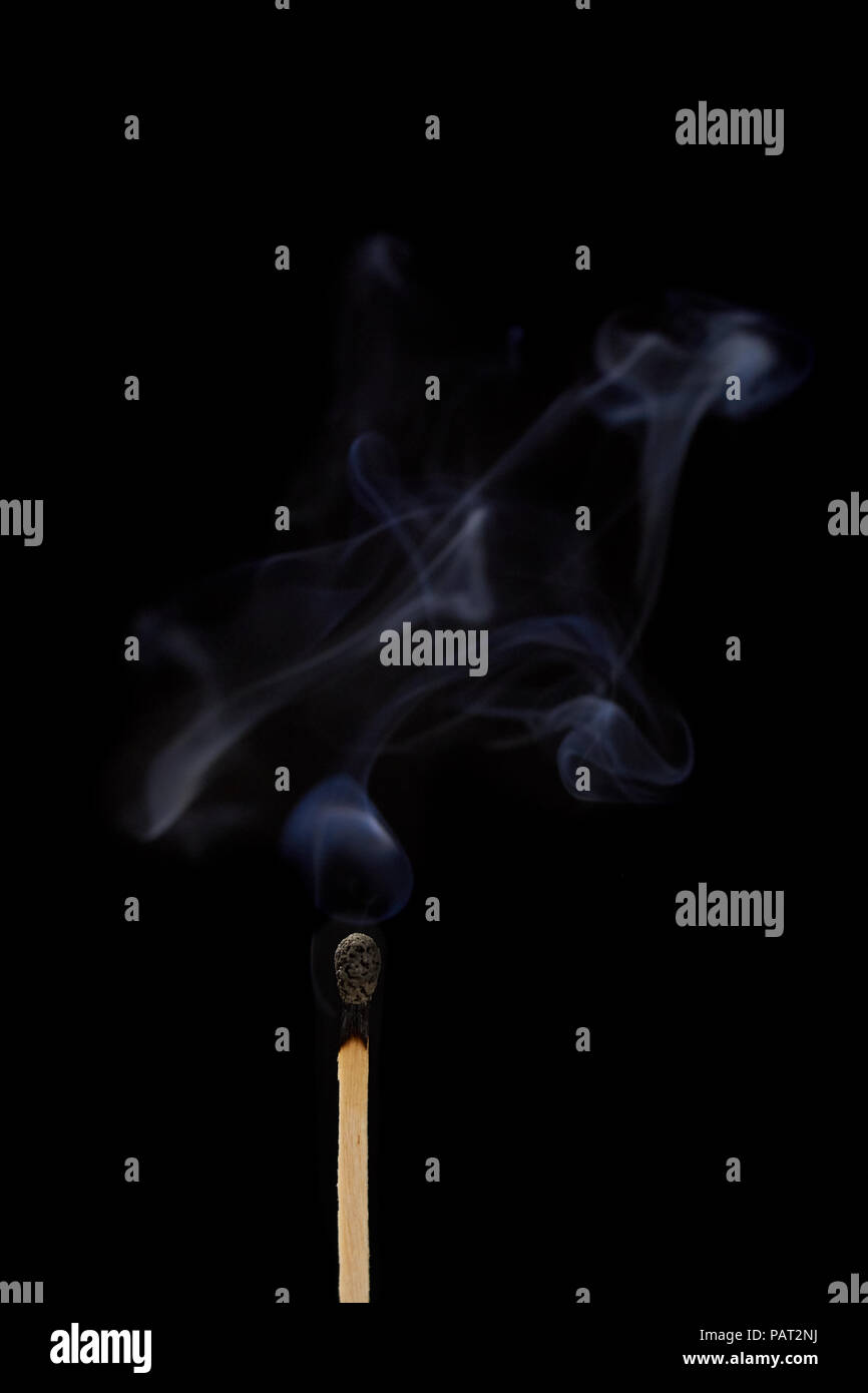 Match off on a black background with smoke Stock Photo - Alamy