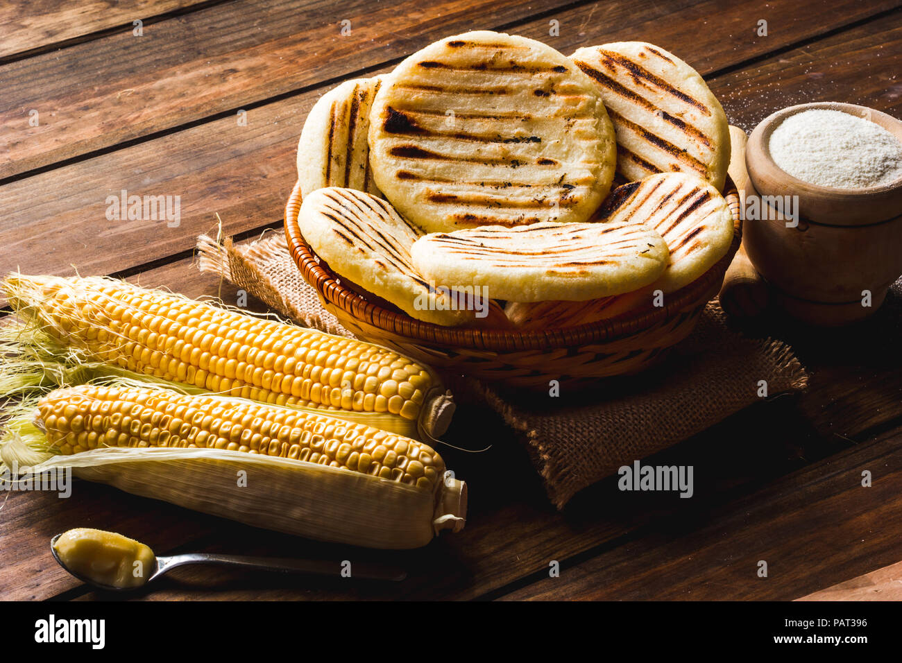 View from High angle of rustic table with several ground corn Arepas ...