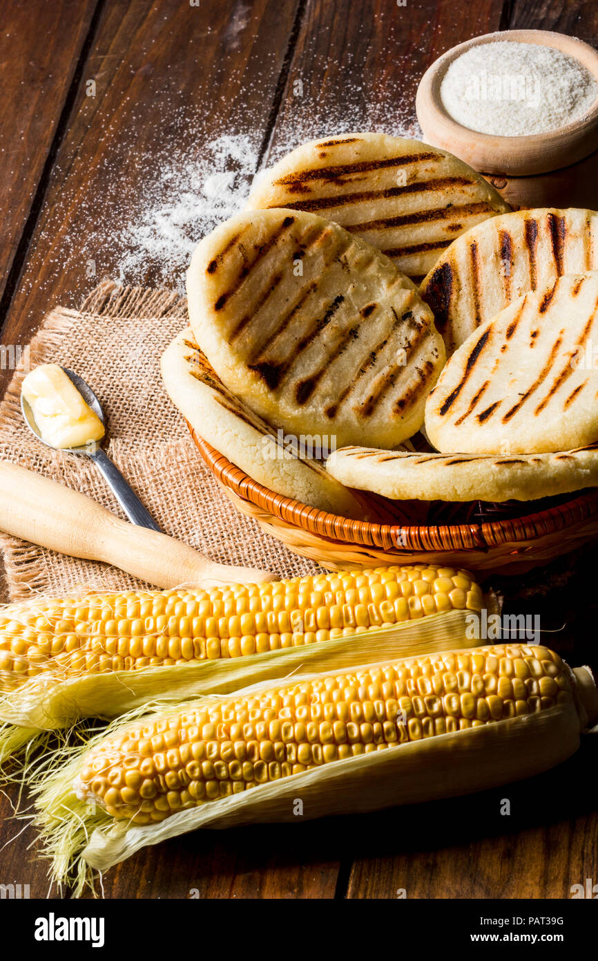 View from High angle of rustic table with several ground corn Arepas ...