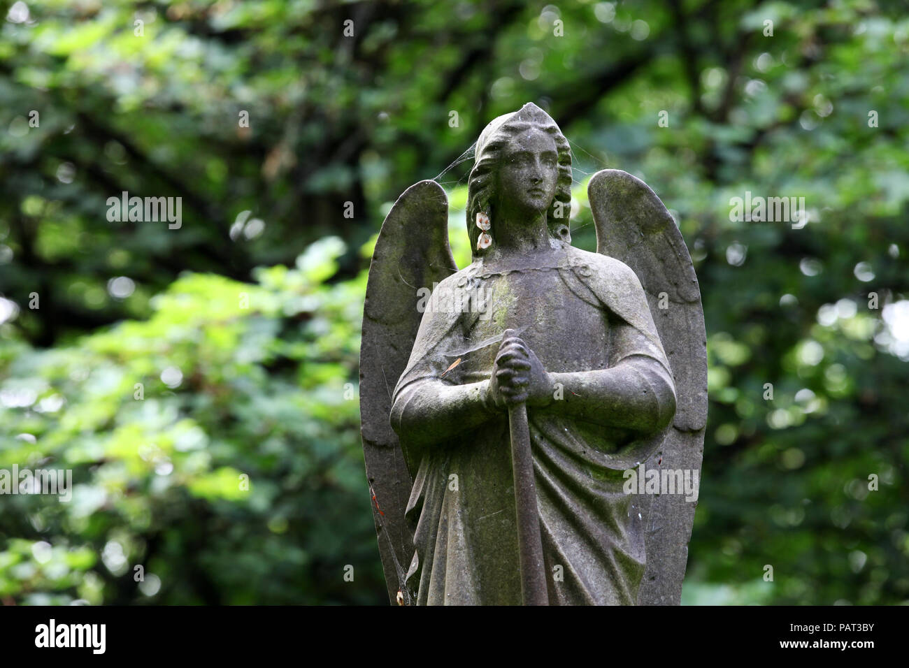 A statue of an angel standing in the grounds of Dalry cemetery in ...