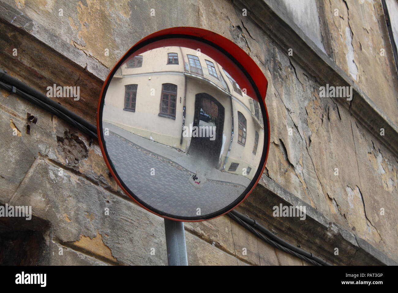 Wall of old building with peeling plaster. Reflection of a neighboring ...