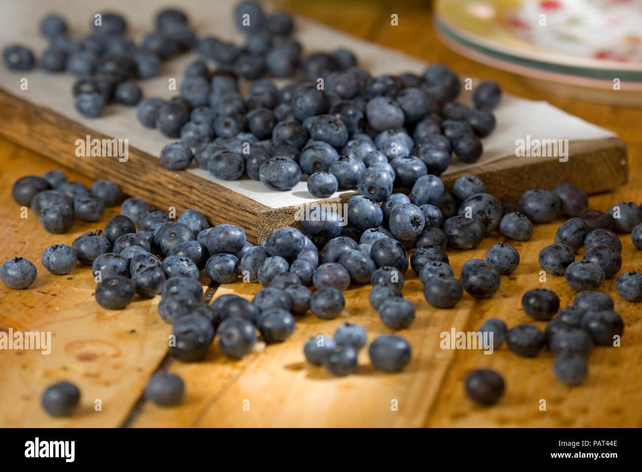 Blueberries on kitchen table Stock Photo - Alamy