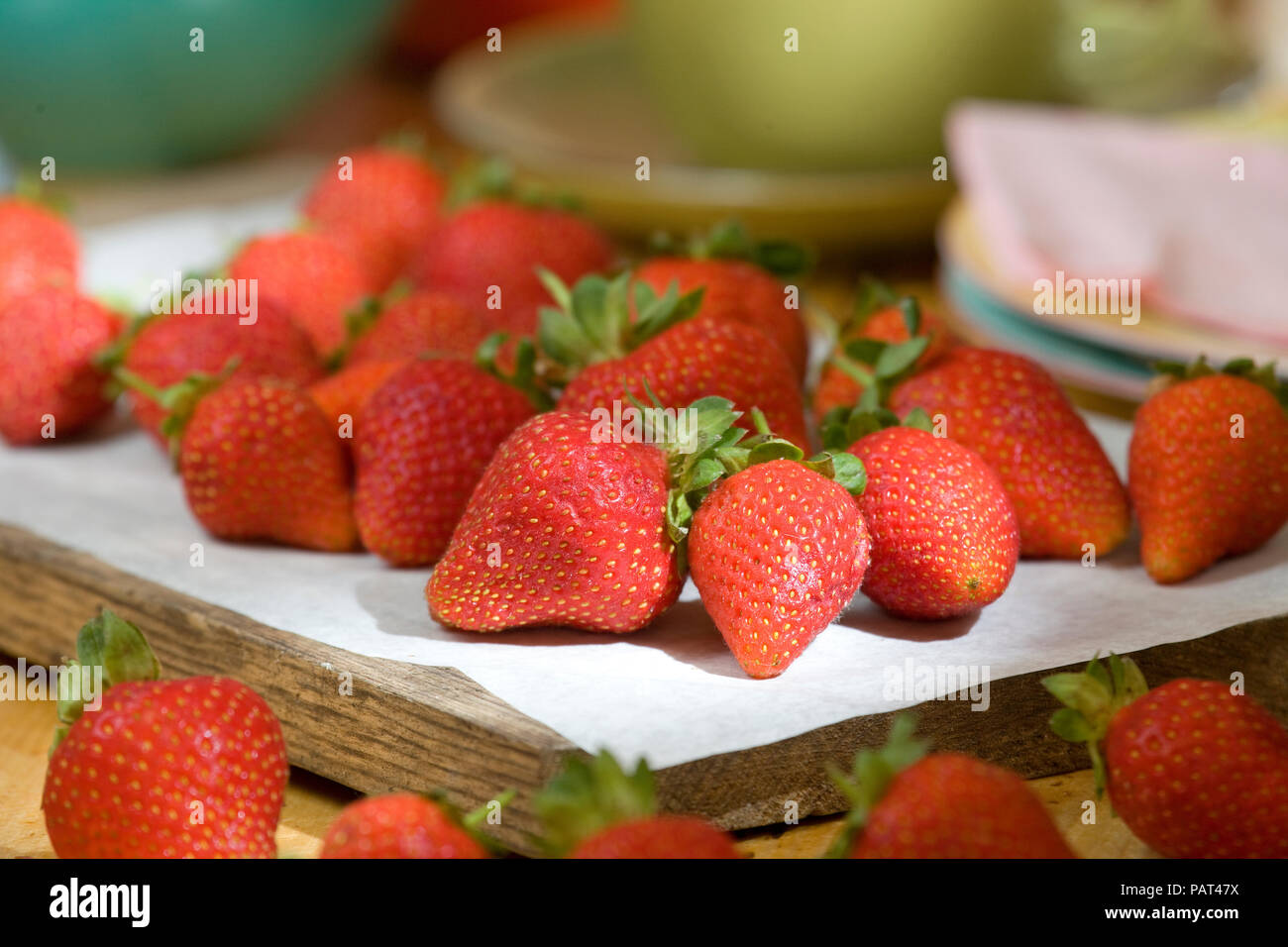 Strawberries on kitchen table Stock Photo - Alamy