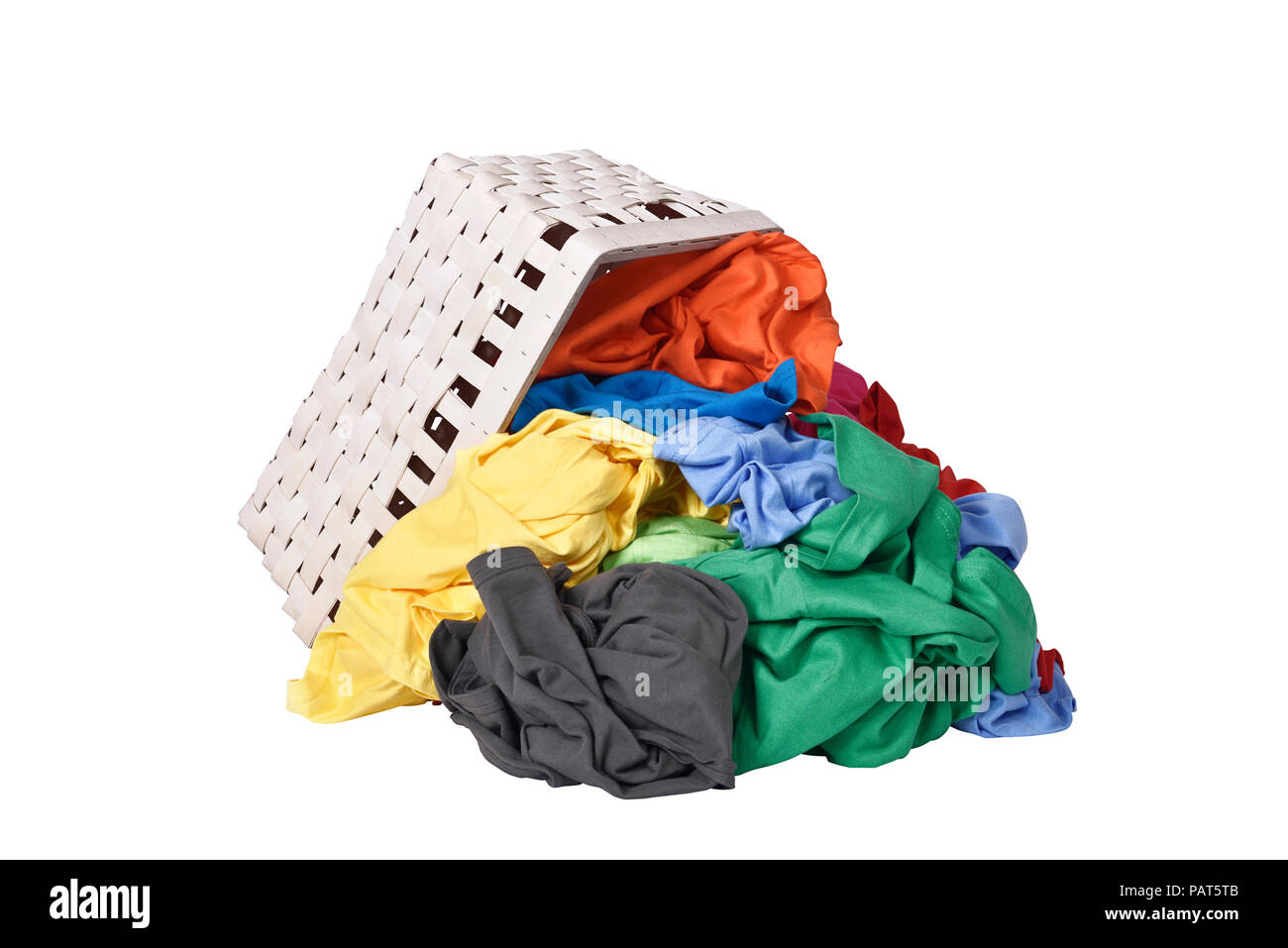Colorful clothes spilled from wooden basket isolated over white ...