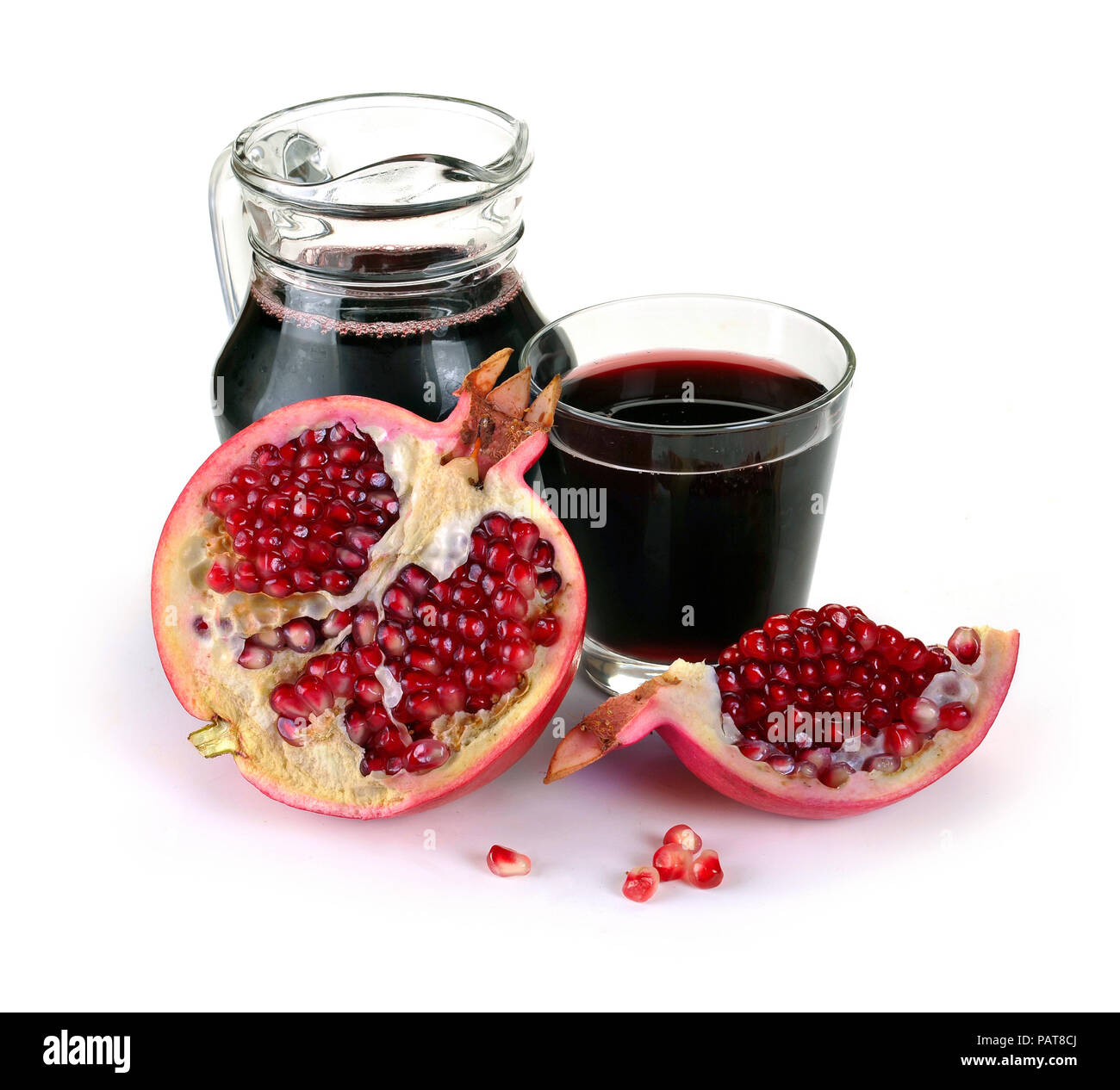 Jug of juice and ripe piece grenade on white background Stock Photo - Alamy