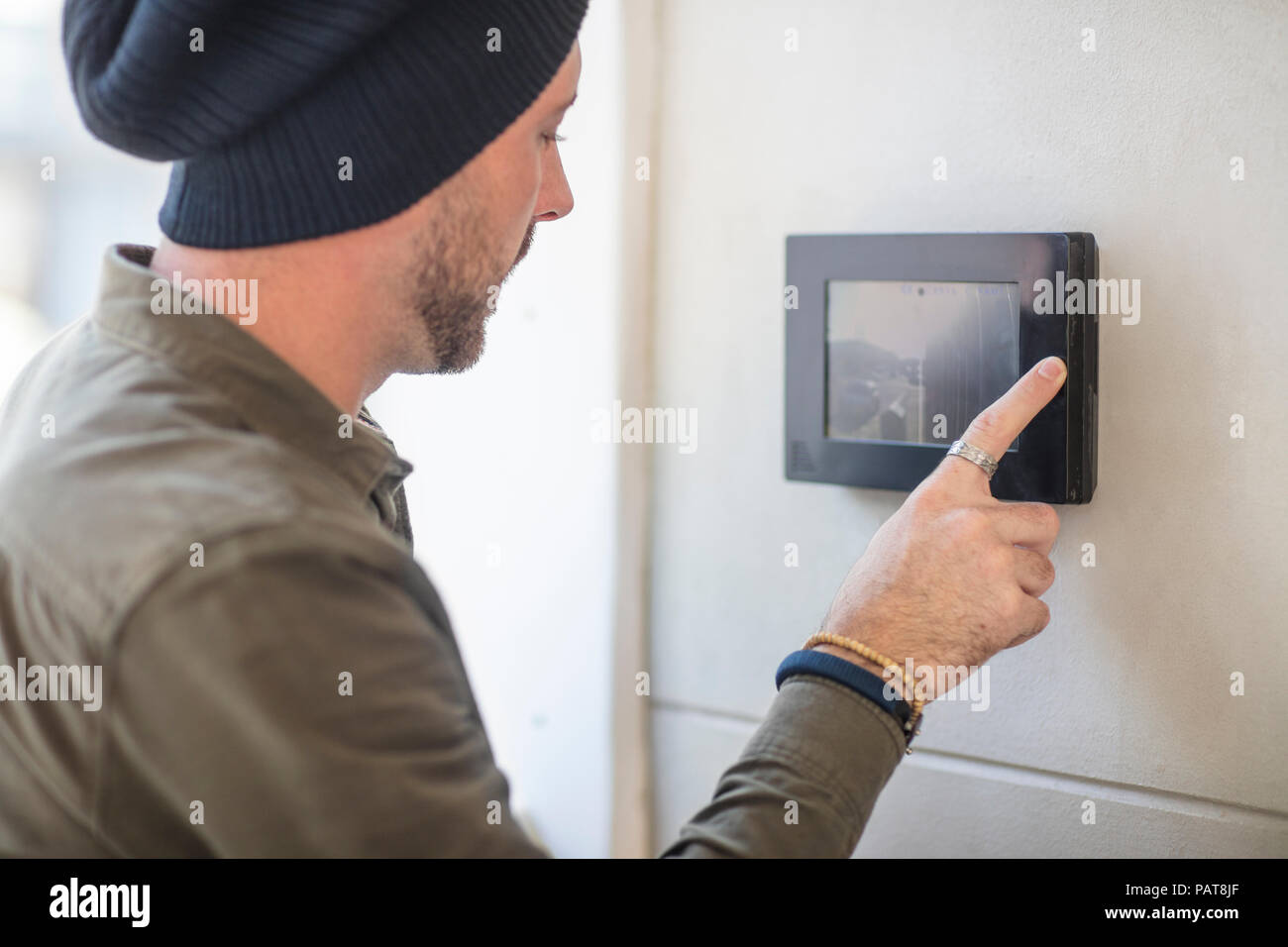 Young man using intercom office hi-res stock photography and images - Alamy