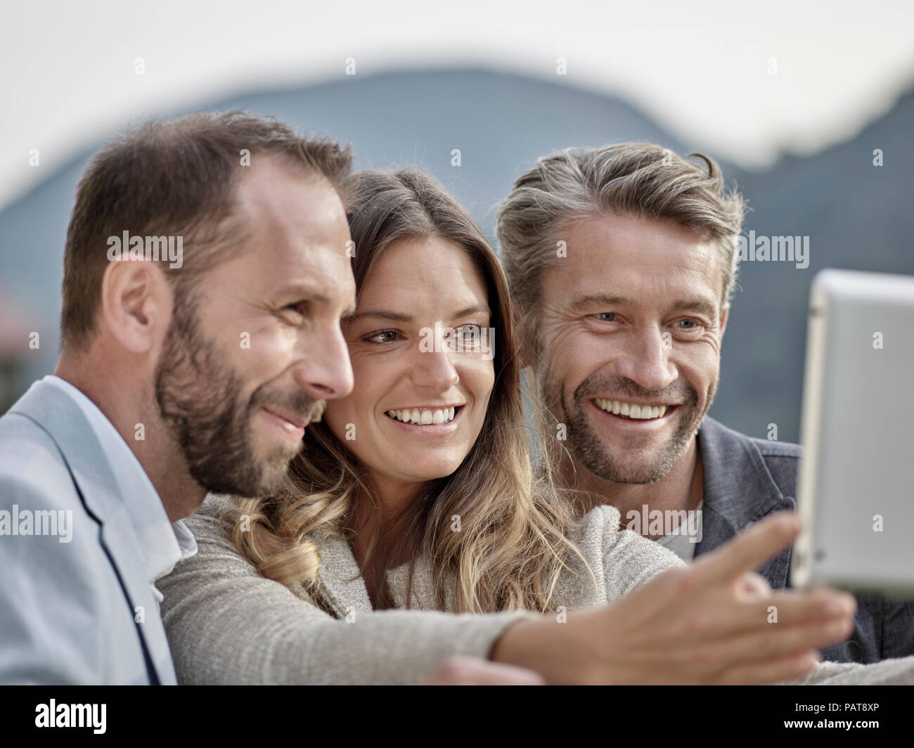 Smiling colleagues taking a selfie Stock Photo - Alamy