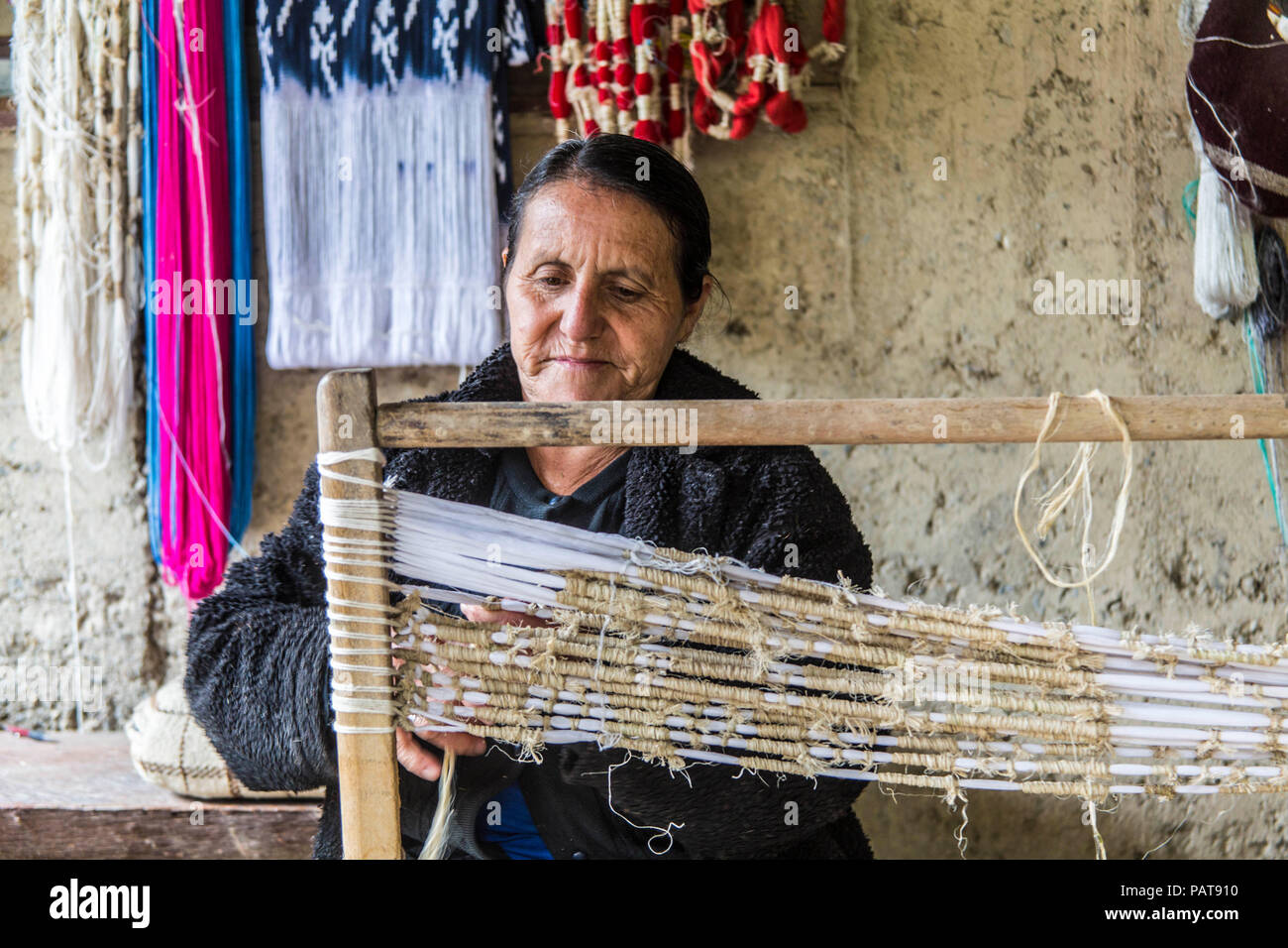 Latin American woman in Cuenca Ecuador weaving on a loom Stock Photo ...