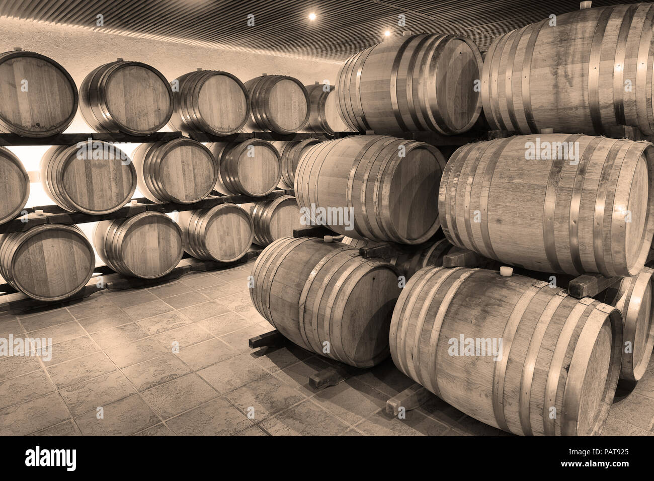 Casks in wine cellar and bottle Stock Photo - Alamy