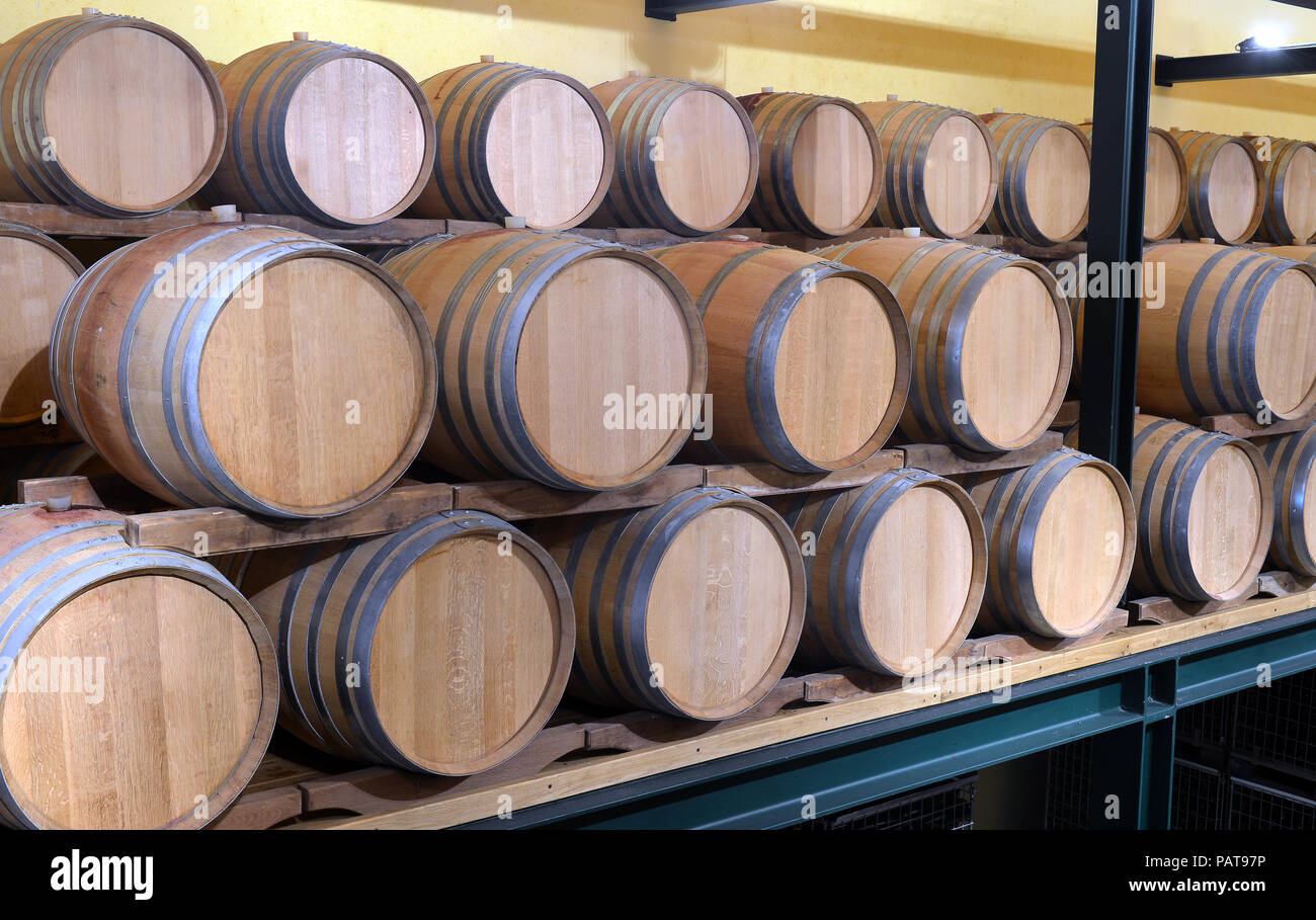 Casks in wine cellar and bottle at the winery Stock Photo - Alamy