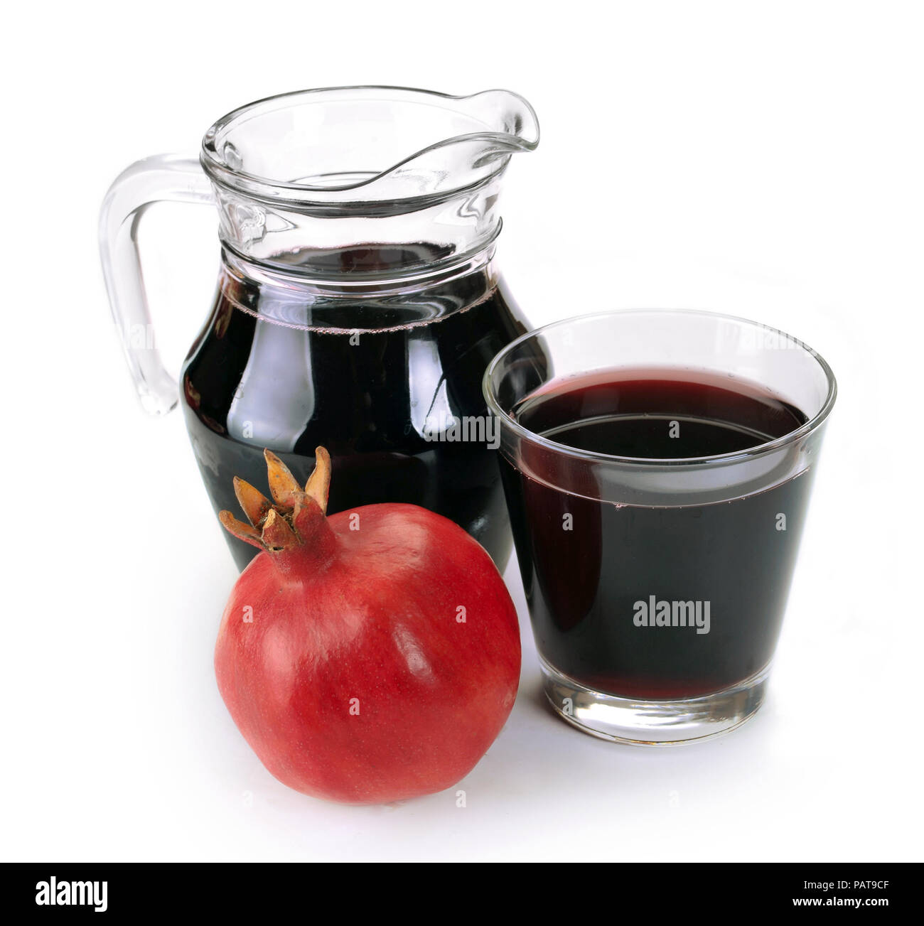 Jug of juice and ripe piece grenade on white background Stock Photo - Alamy