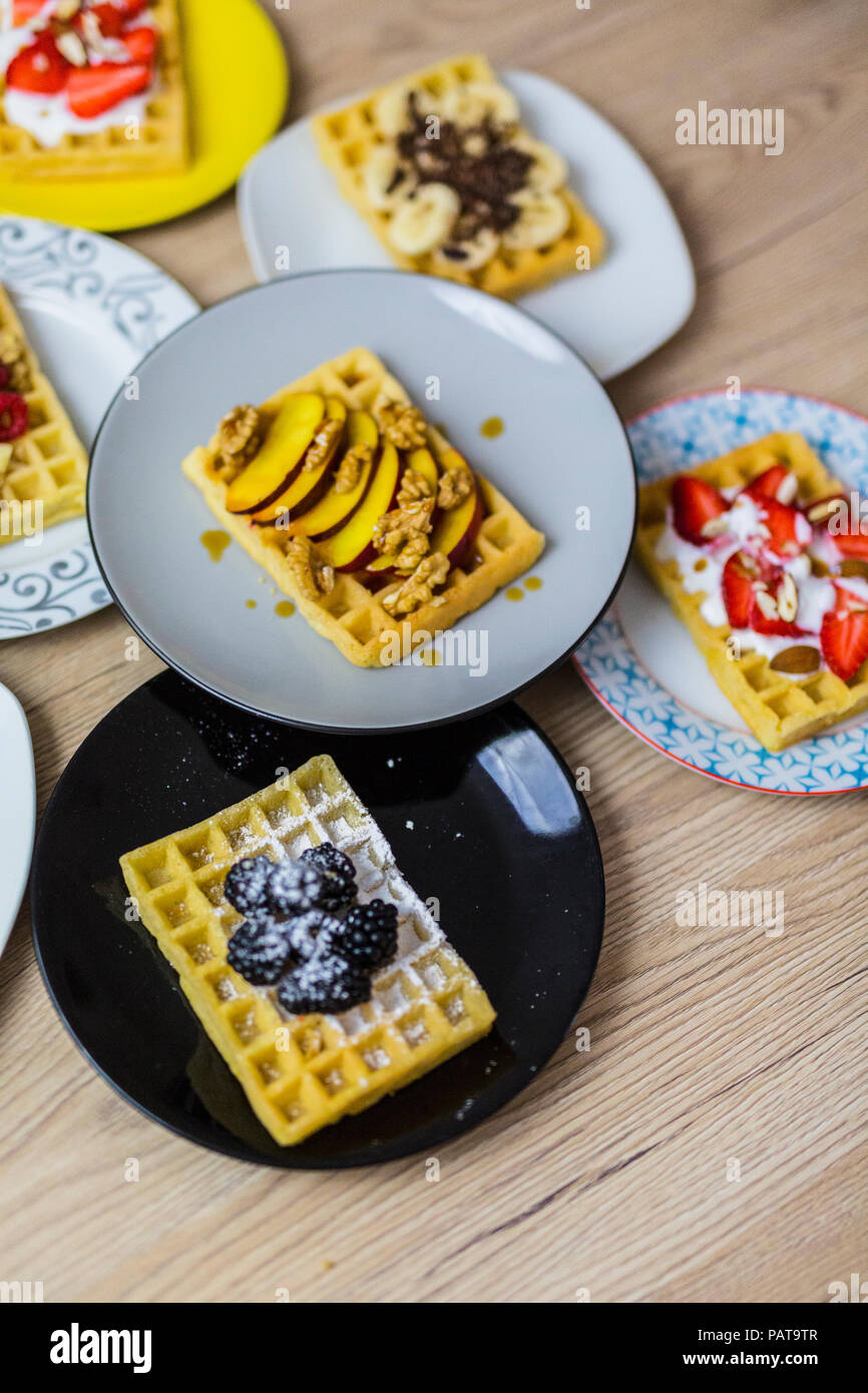 Plates of waffles with various toppings Stock Photo - Alamy