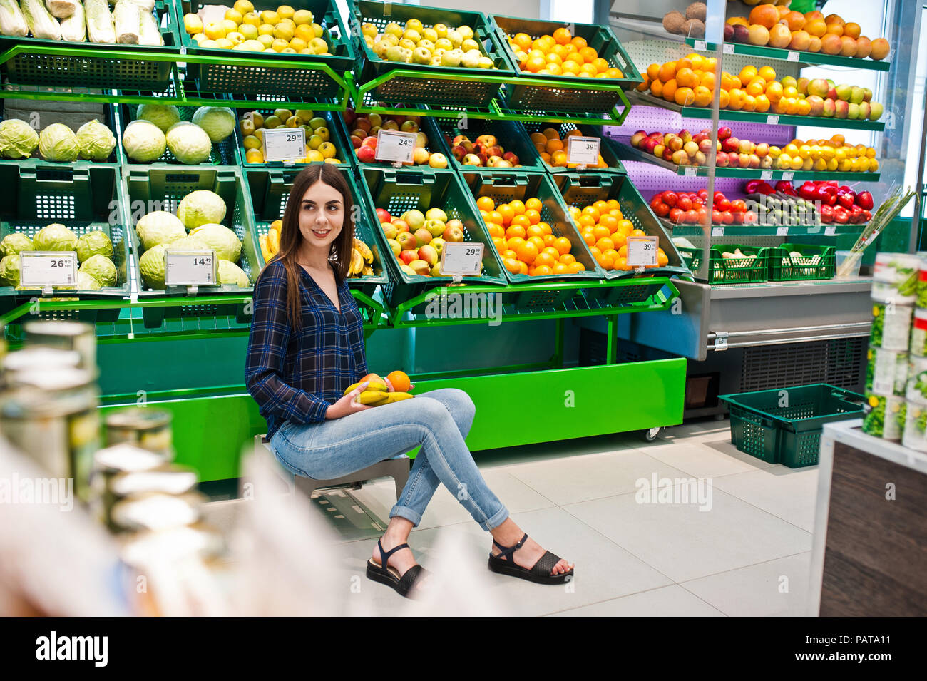 Shopping woman looking at the shelves in the supermarket. Portrait of a ...