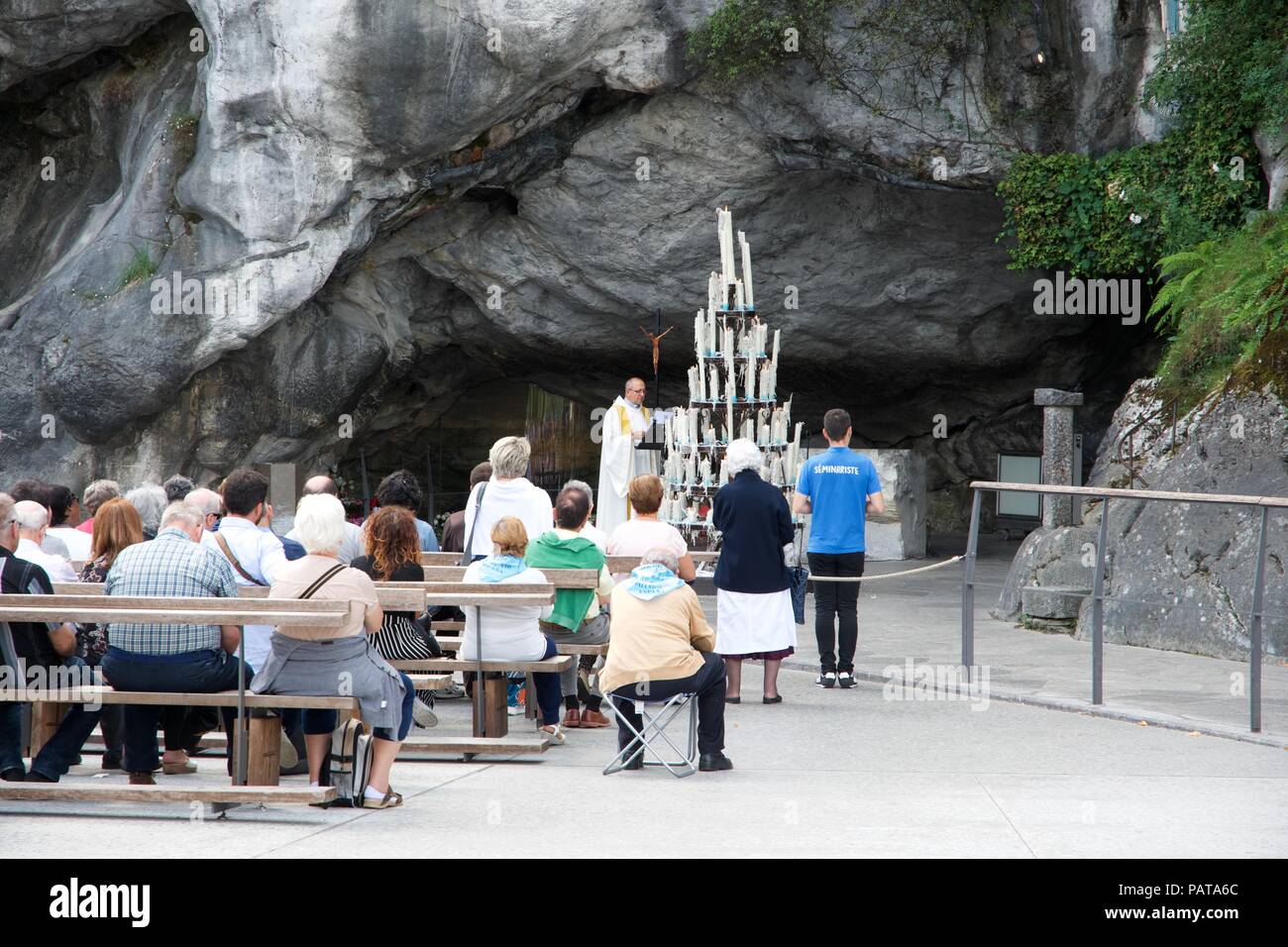 Pilgrims praying in grotto hi-res stock photography and images - Alamy