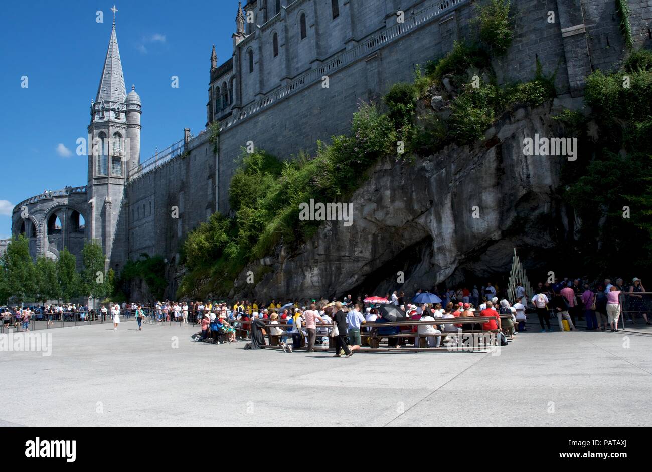 Pilgrims praying at the grotto in Lourdes, Hautes Pyrenees, France ...