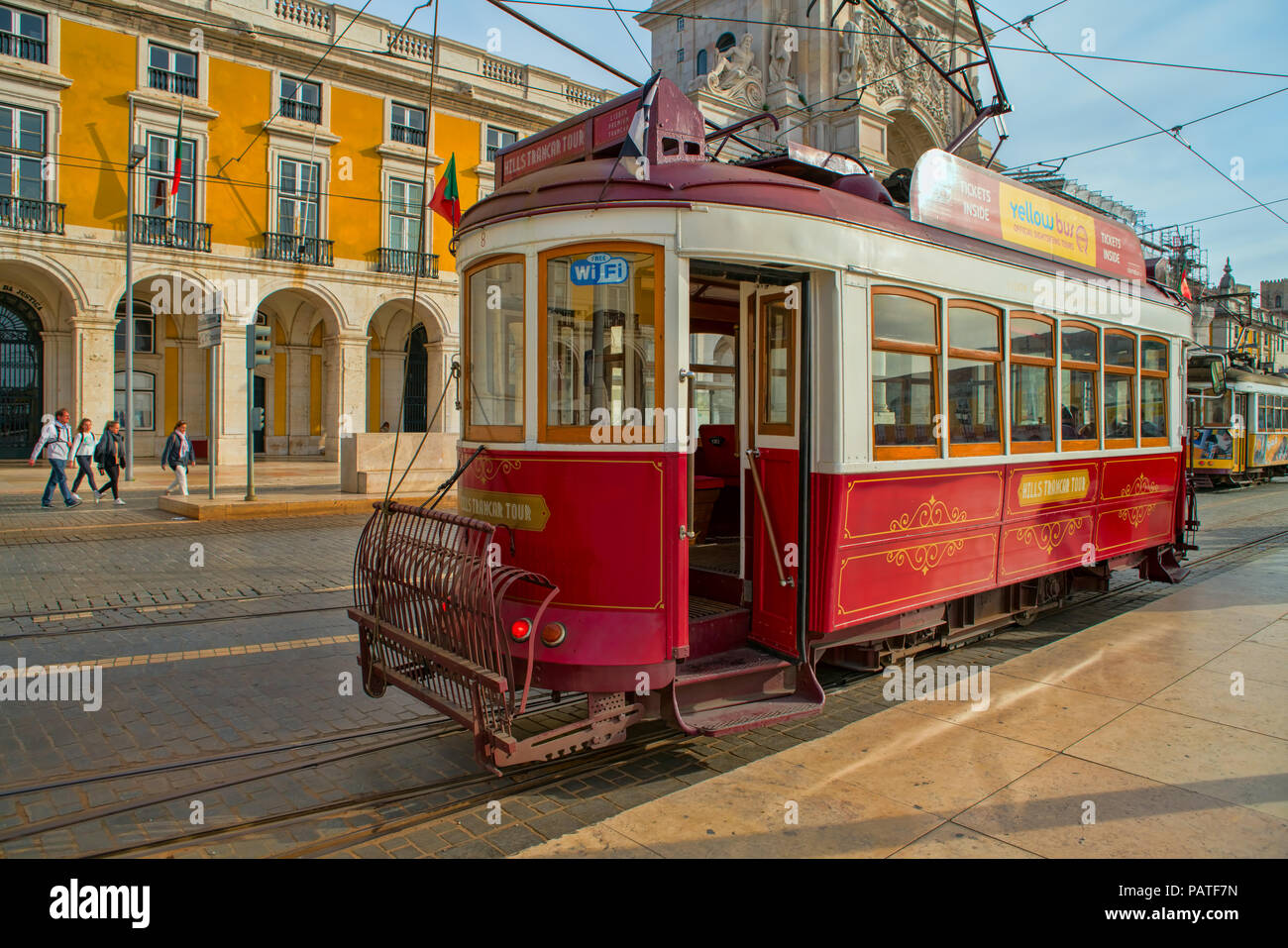 Traditional red tram on a street near Praca de Comercio in Lisbon Stock ...