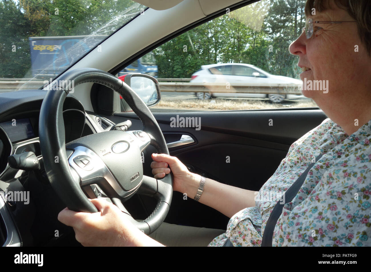 Woman driving in car on Edinburgh City Bypass Stock Photo - Alamy