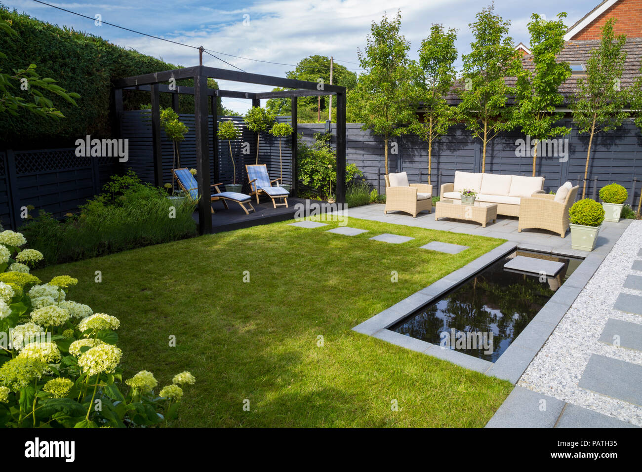Overview of garden borders with a cube pergola, seating area, pool and ...