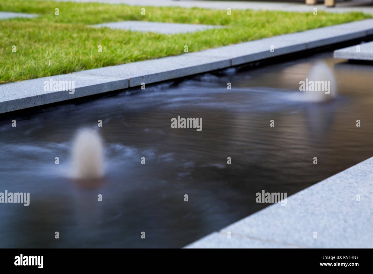 A pool water feature in motion Stock Photo - Alamy