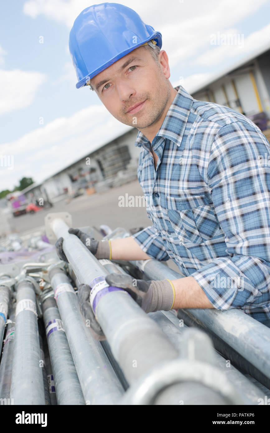 worker filing the poles Stock Photo - Alamy