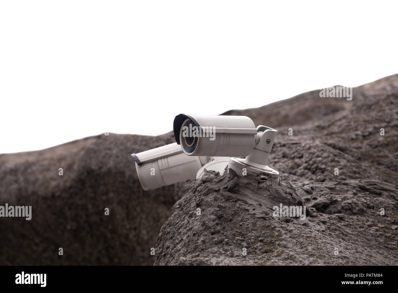 Surveillance Security Camera on the rock isolated on white background ...
