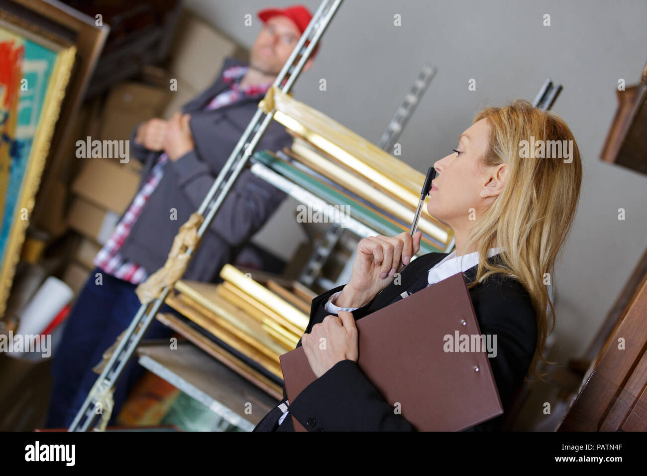 female manager giving orders to subordinate in warehouse Stock Photo ...