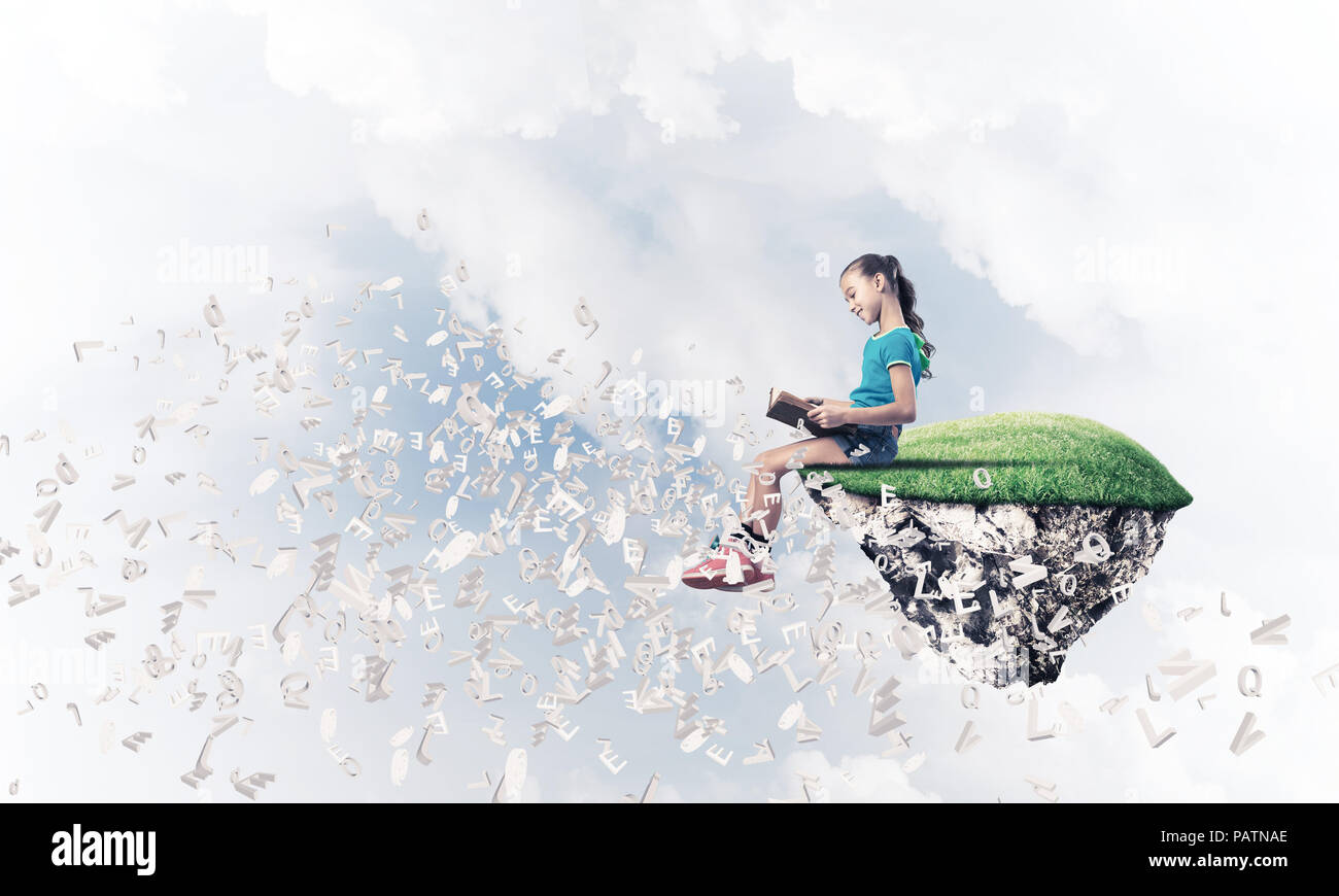 Girl of school age reading book as concept for education Stock Photo ...