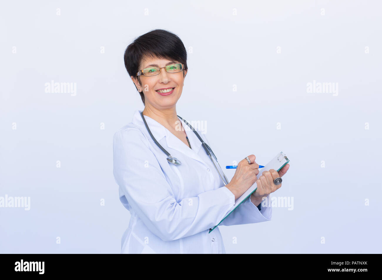 Medical doctor writing prescription over white background with ...