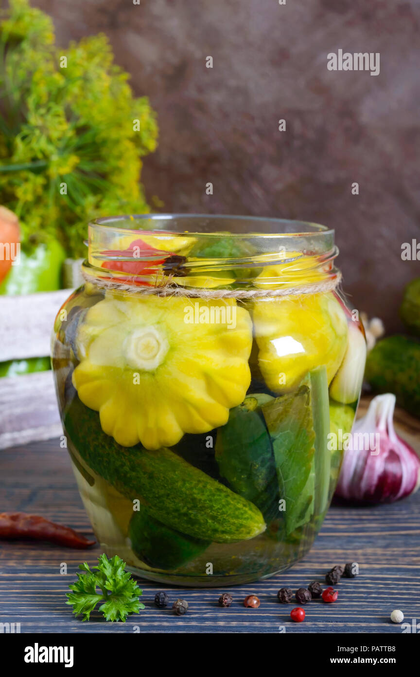 Marinated vegetables in a glass jar. Assorted cucumbers, peppers ...