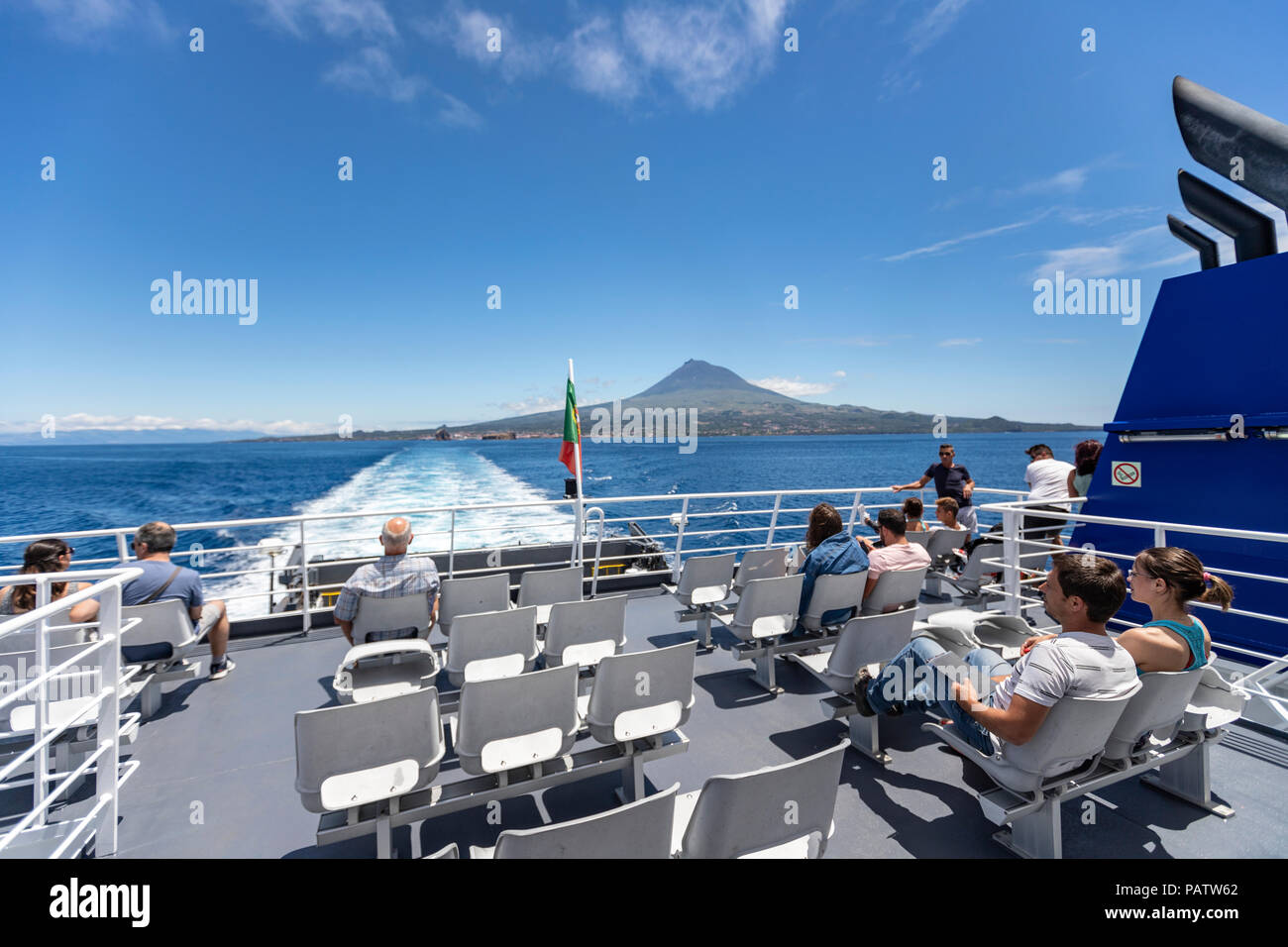 Passengers in the ferry top deck to Horta, Madalena, Pico island ...