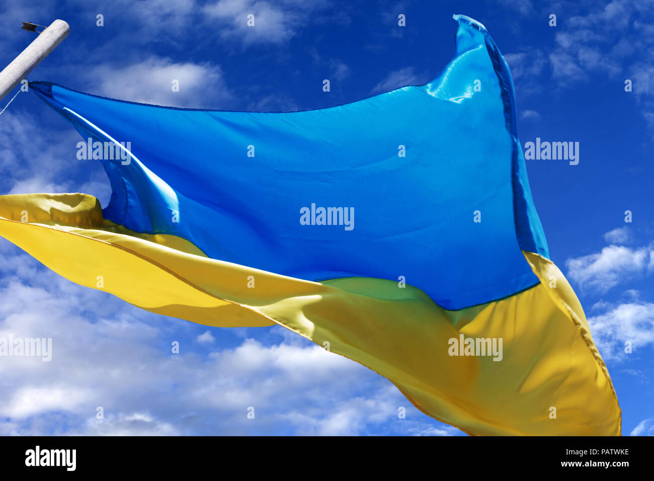 Flag of Ukraine waving in wind on blue sky with clouds at sun day Stock ...