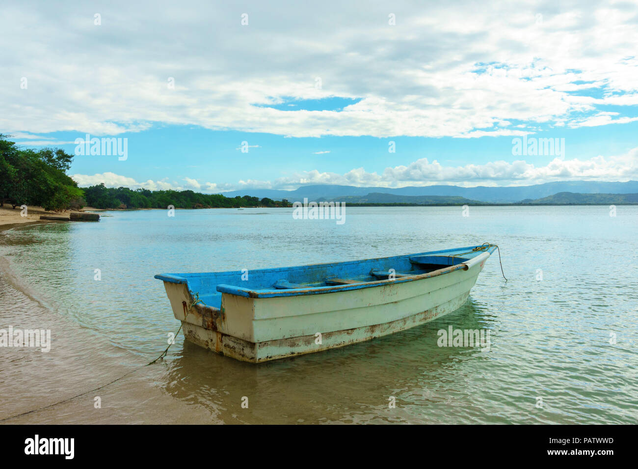 old white blue empty wooden boat on the river Bank Stock Photo - Alamy