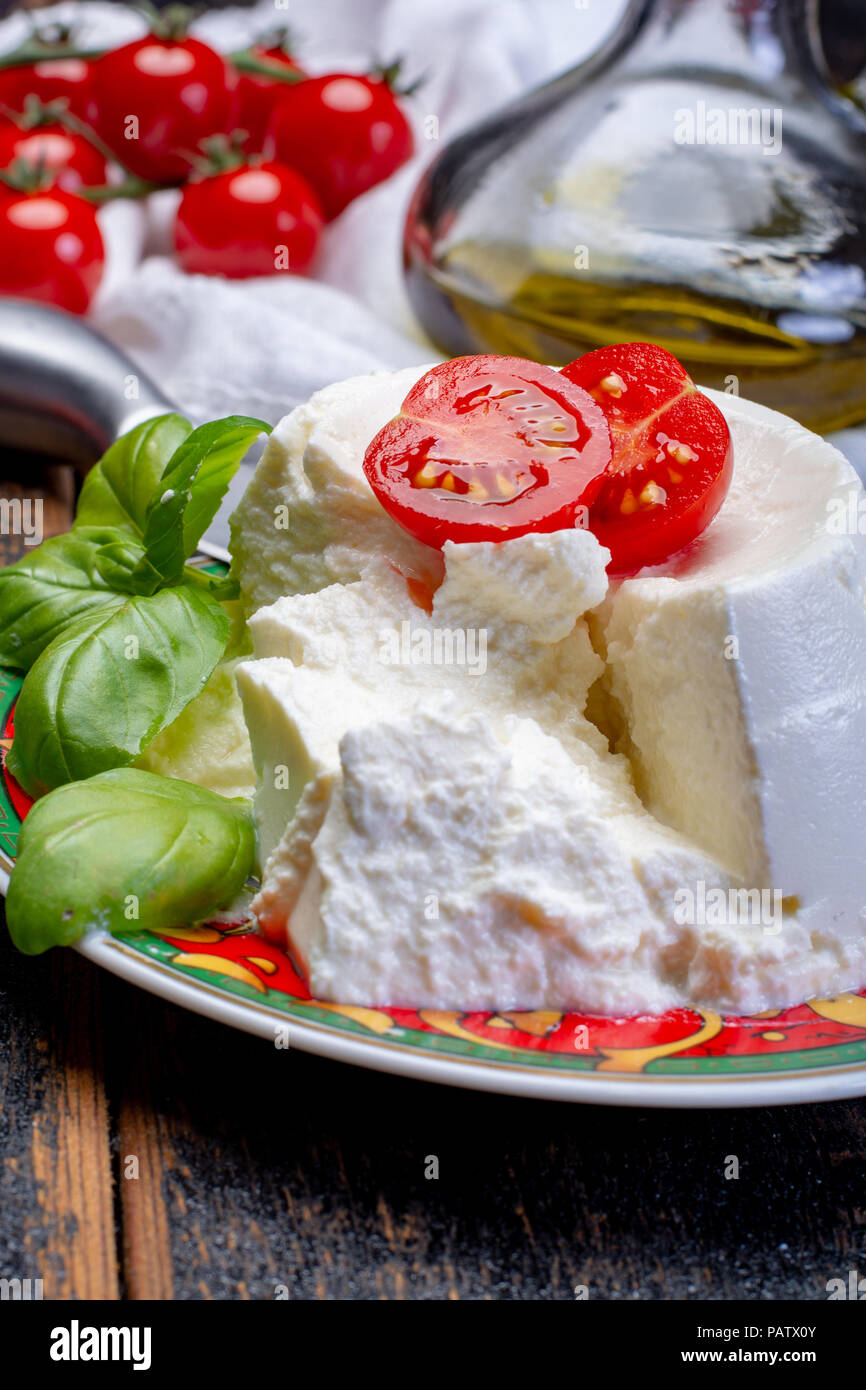 Italian soft cheese, young white ricotta cheese served with fresh basil ...
