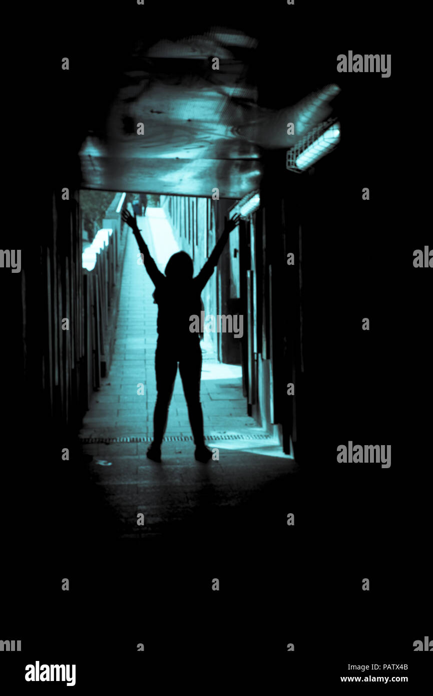 Woman alone and sad in a tunnel. Scene of mystery and desolation Stock ...