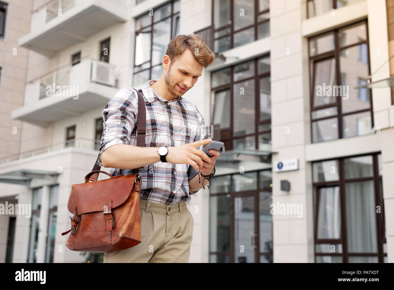 Smart young man using his mobile phone Stock Photo - Alamy