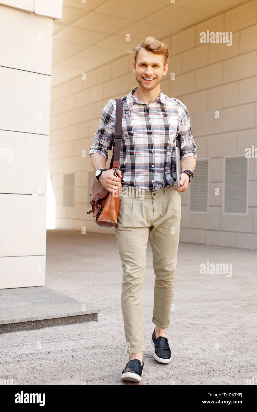 Positive young man walking Stock Photo - Alamy