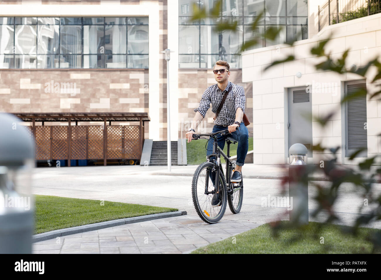 Nice young man riding a bike Stock Photo - Alamy